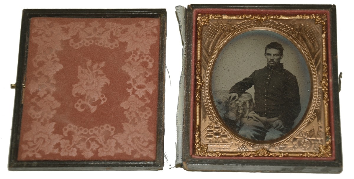 CASED 1/6 PLATE AMBROTYPE OF A SEATED SOLDIER, WITH A PATRIOTIC MAT ...
